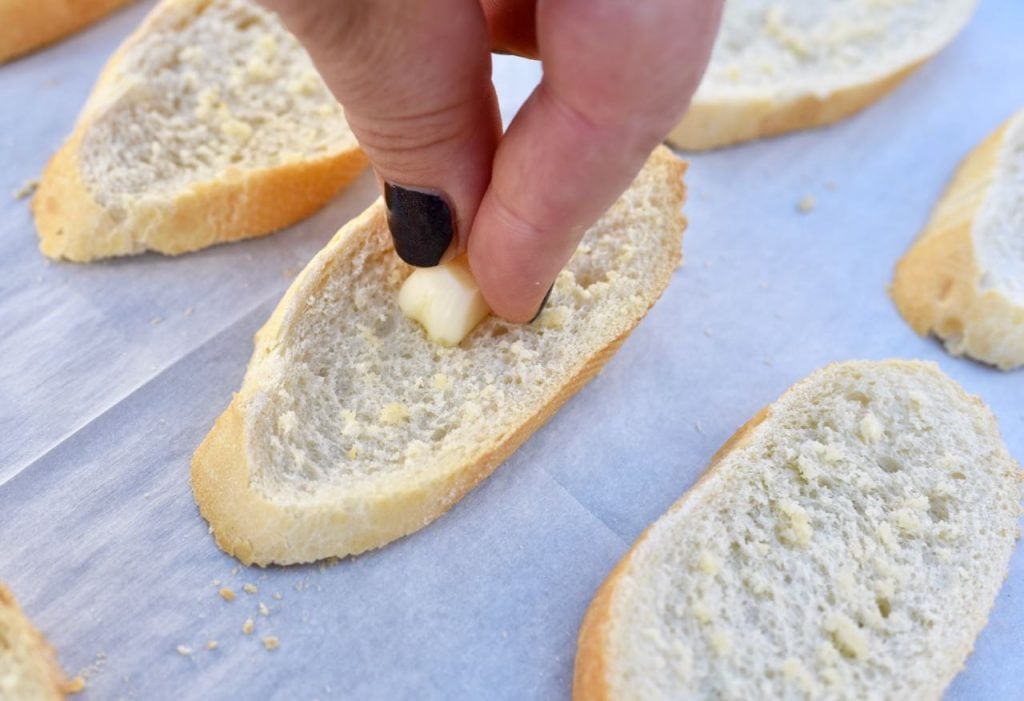 rub-the-garlic-on-the-bread-for-the-bruschetta-recipe - Make Life Lovely