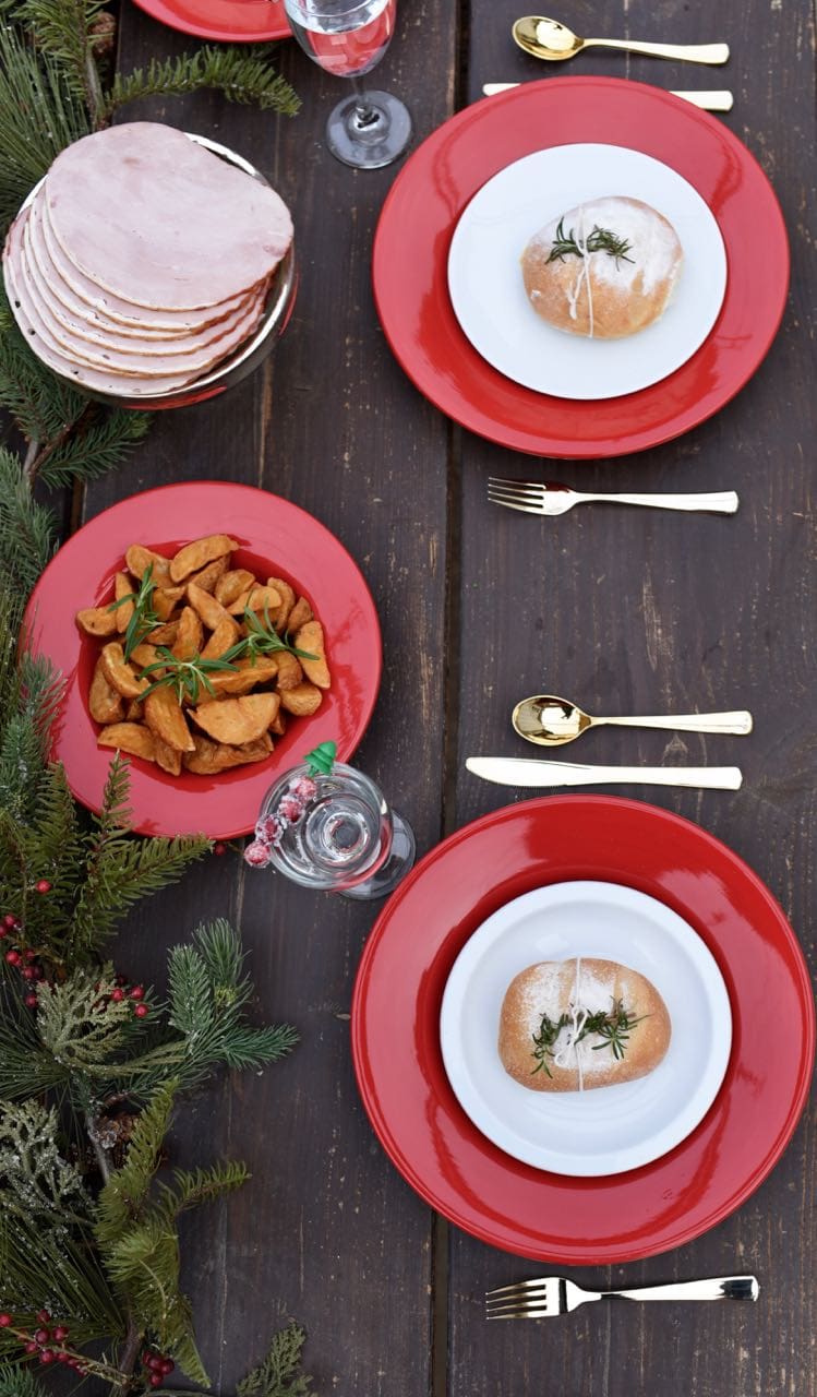 Holiday dinner party on long rustic farmhouse table - Make Life Lovely